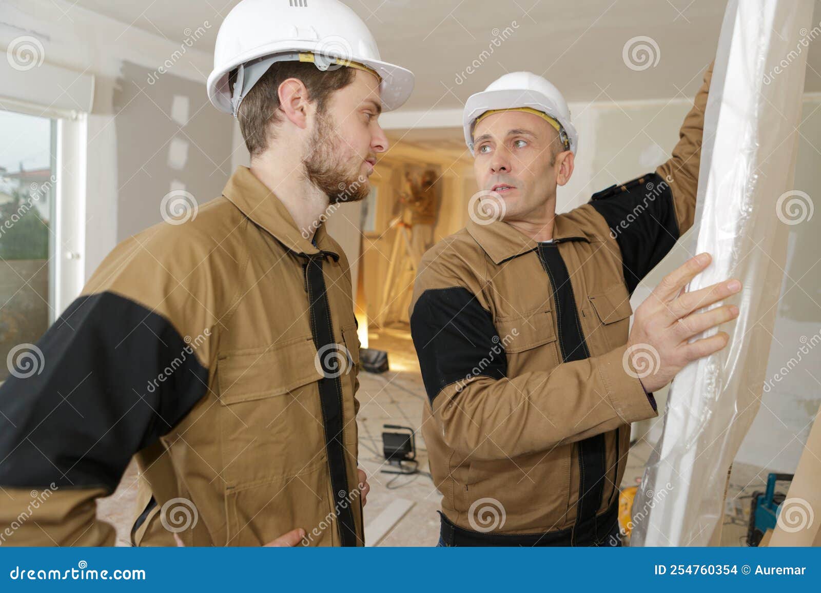 Two Carpenters Working at Construction Site Stock Photo - Image of dust ...