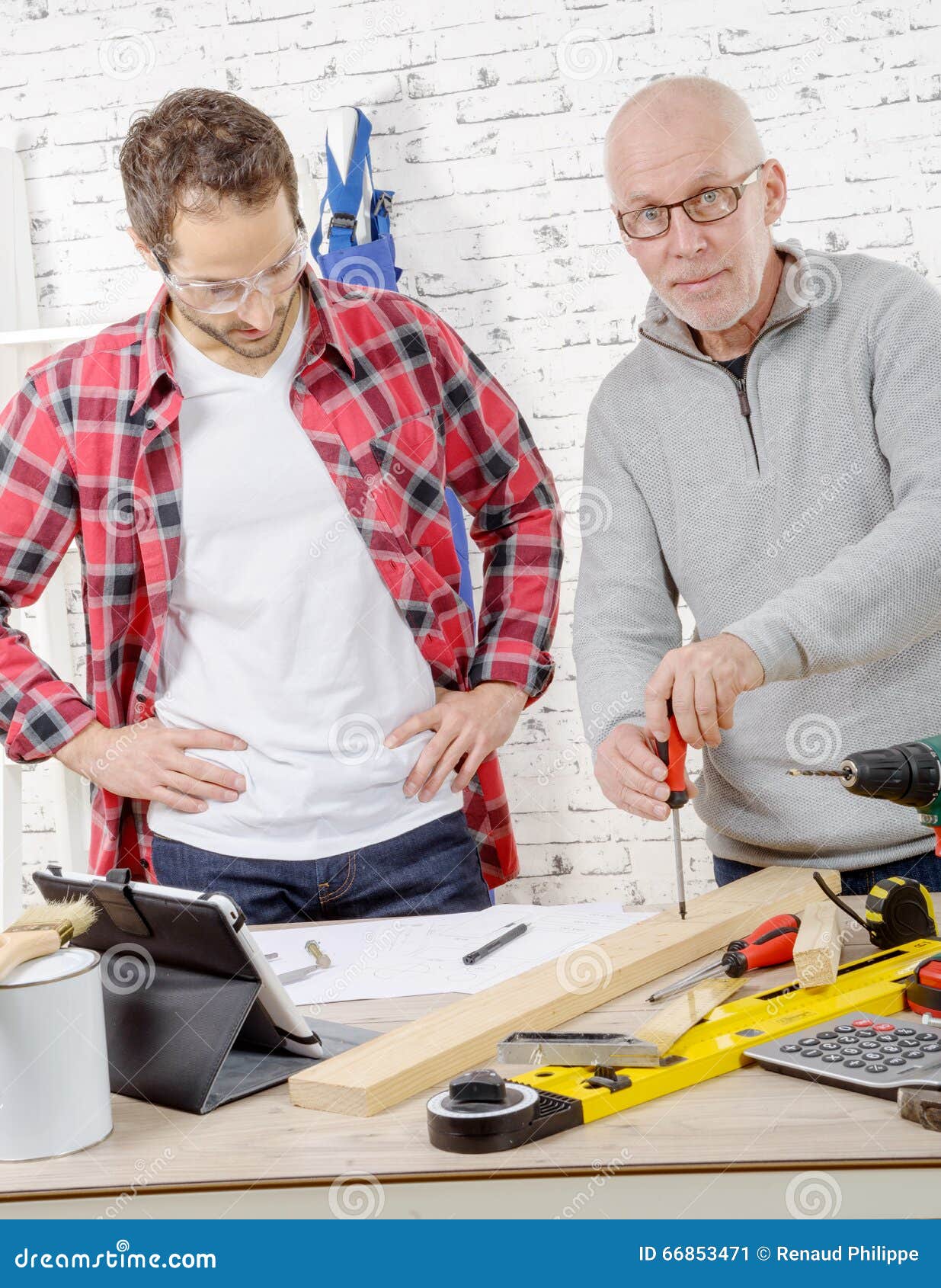 Two Carpenters Working in Office, One with Screwdriver Stock Image ...