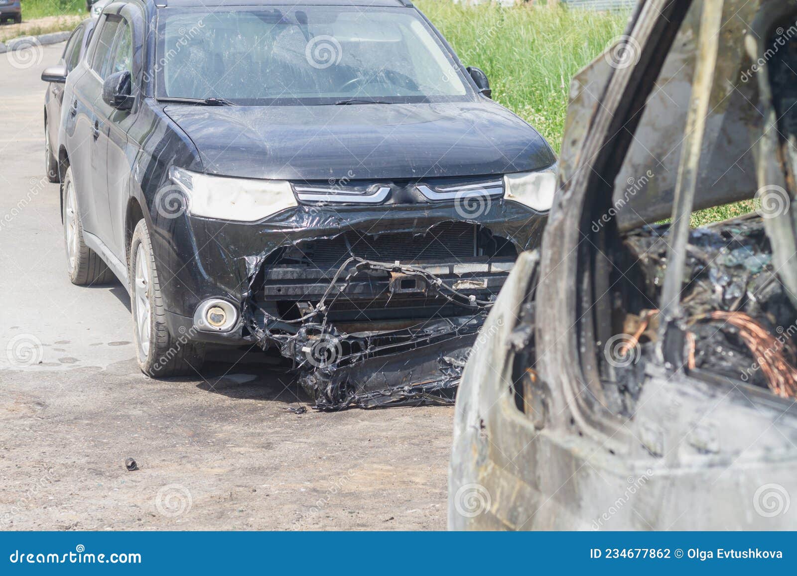 Burned Car After An Accident On The Asphalt Road. Front View. Arson Of ...