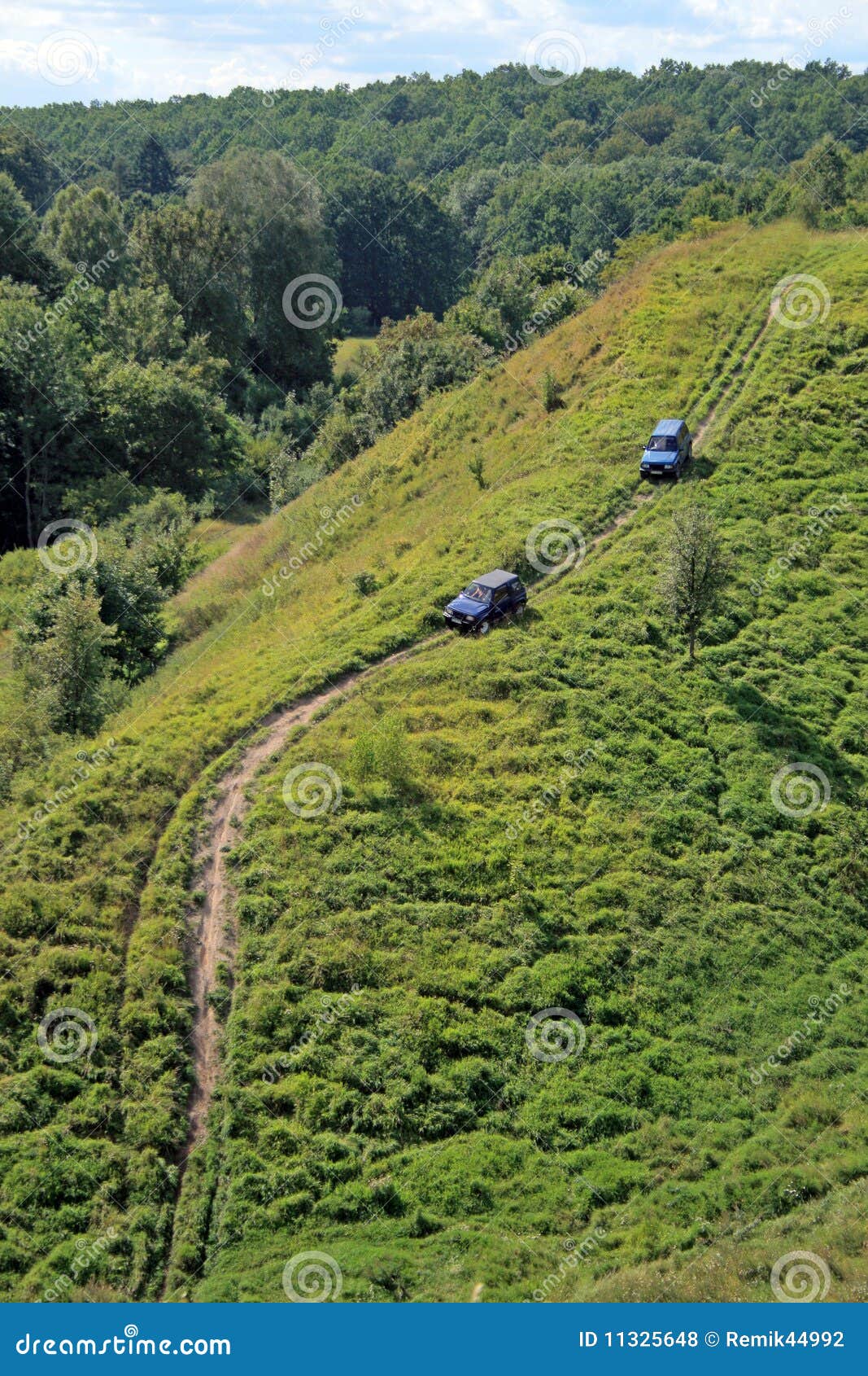 Two Cars Climbing Up the Slope Stock Photo - Image of land, grass: 11325648
