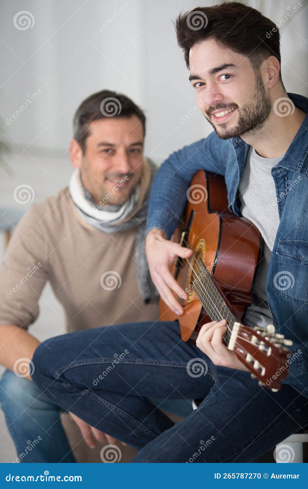 Two Casually Dressed Men One Playing Guitar Stock Photo - Image of ...