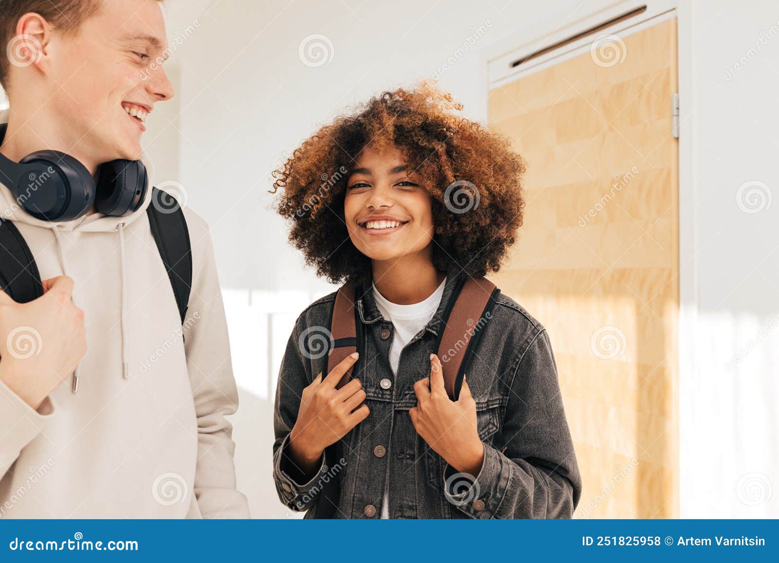 Two Cheerful Classmates Standing Together in Corridor Stock Photo ...
