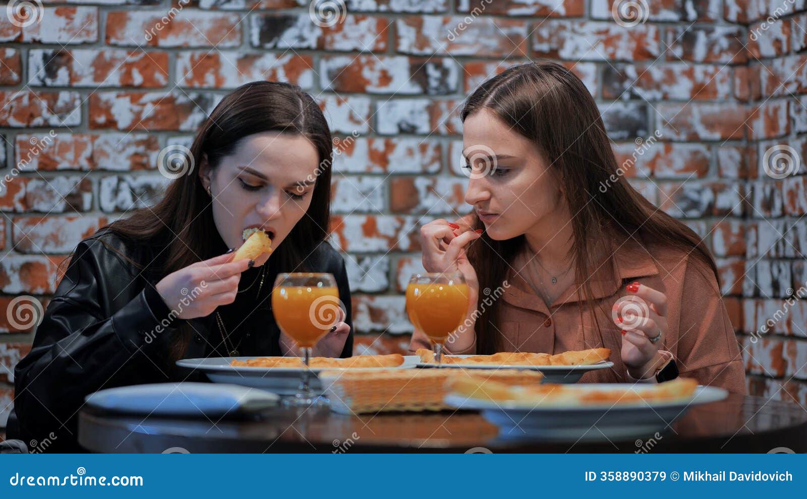 Two Cheerful Girls in a Cafe Having Dinner. Stock Image - Image of ...