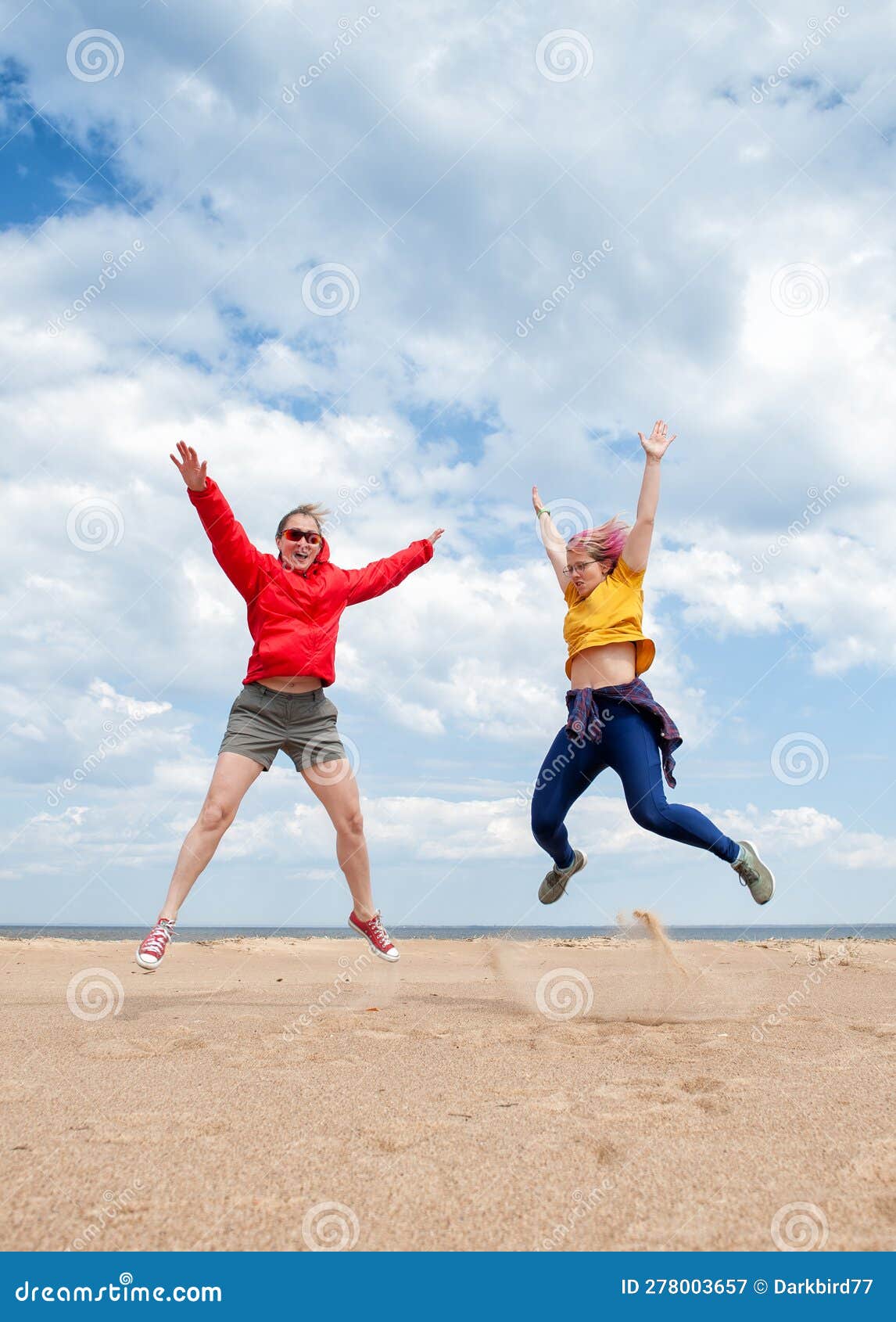 Two Cheerful Women Having Fun and Jumping on the Sand Stock Image ...