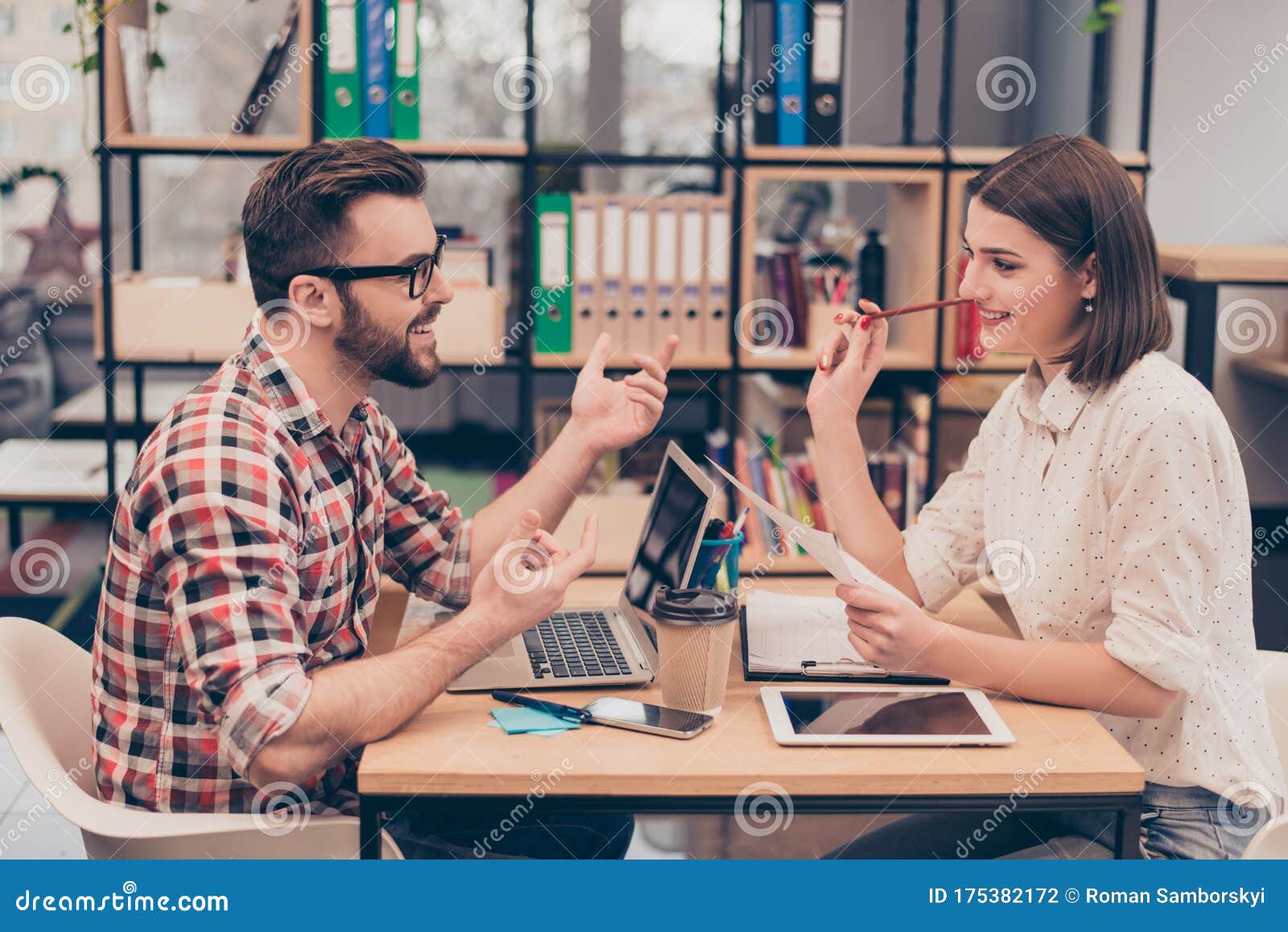Two Cheerful Young Business People Working on Project Together Stock ...