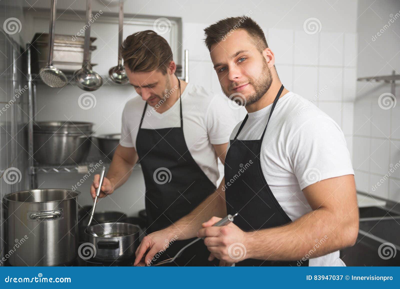 Two chef cooking together stock image. Image of caucasian - 83947037