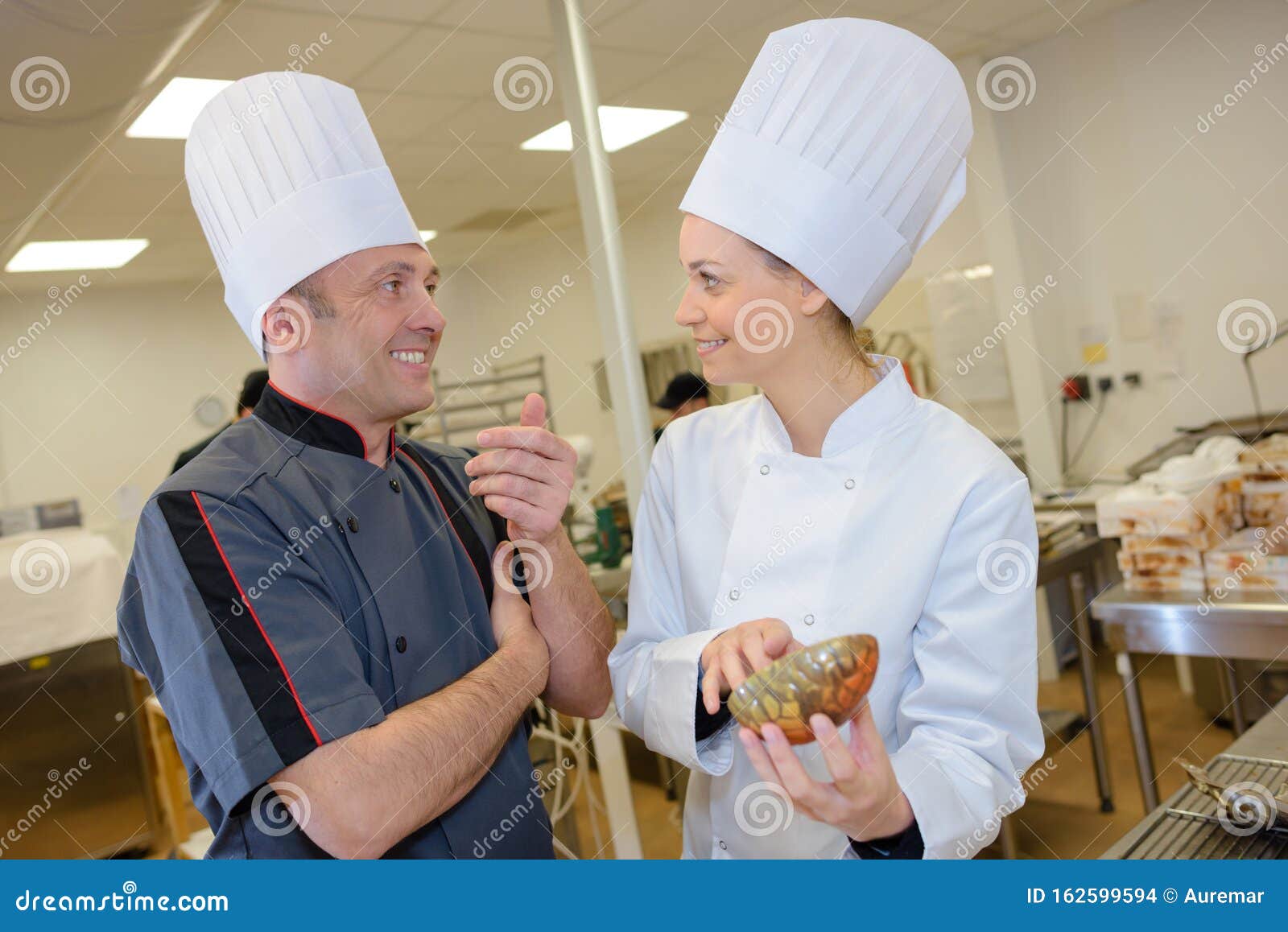Two chefs laughing at work stock photo. Image of sweet - 162599594
