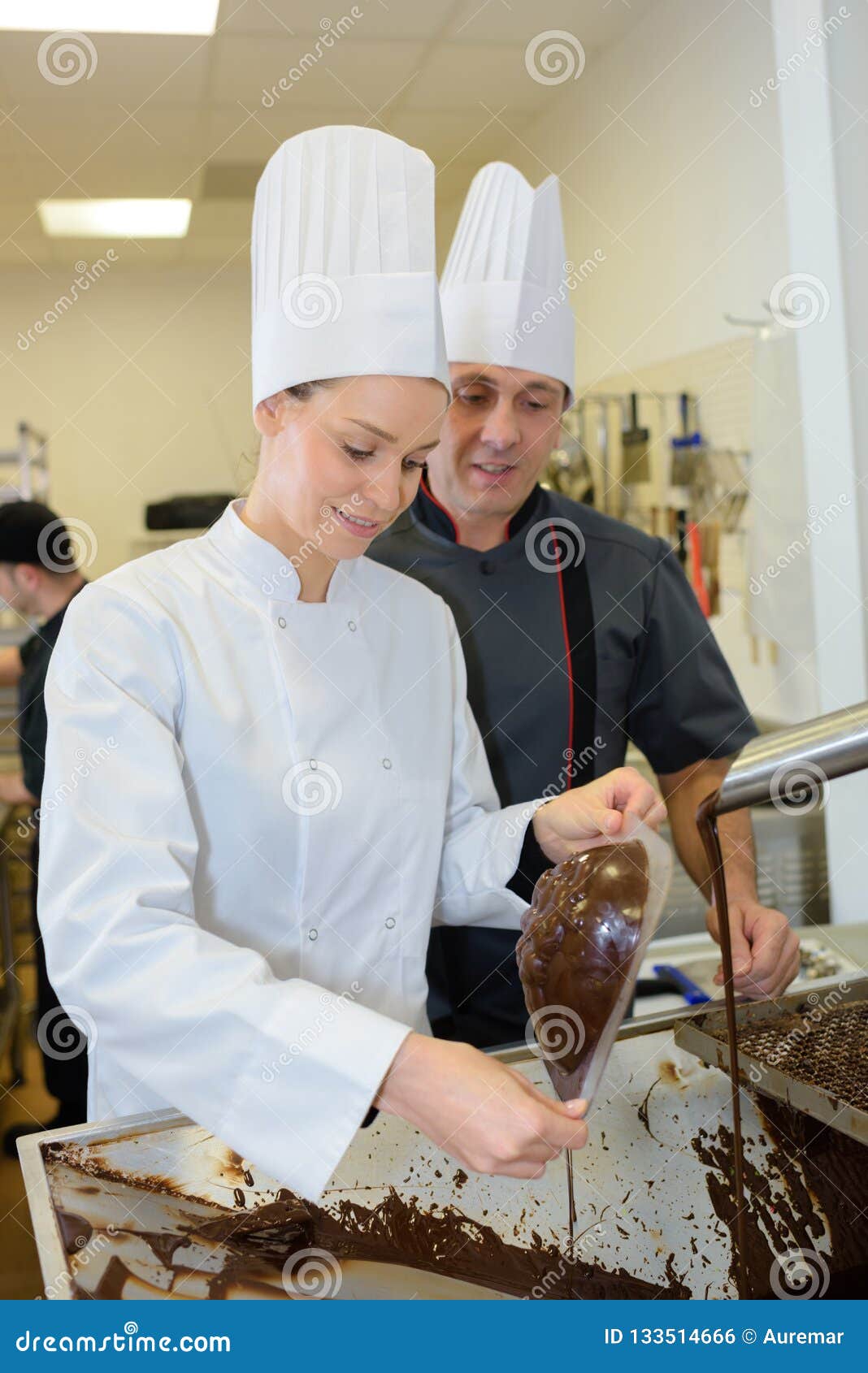 Two Chefs in Teamwork - Preparing Chocolate Stuffing Stock Photo ...