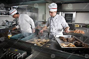 Two chefs at work stock photo. Image of gourmet, chef - 6401604