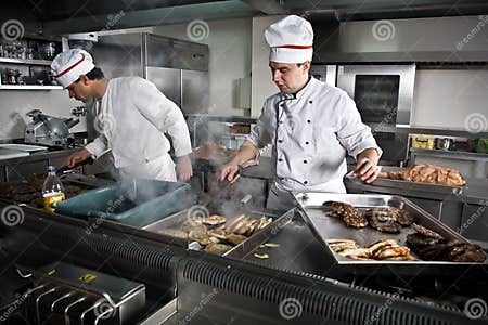 Two chefs at work stock photo. Image of gourmet, chef - 6401604