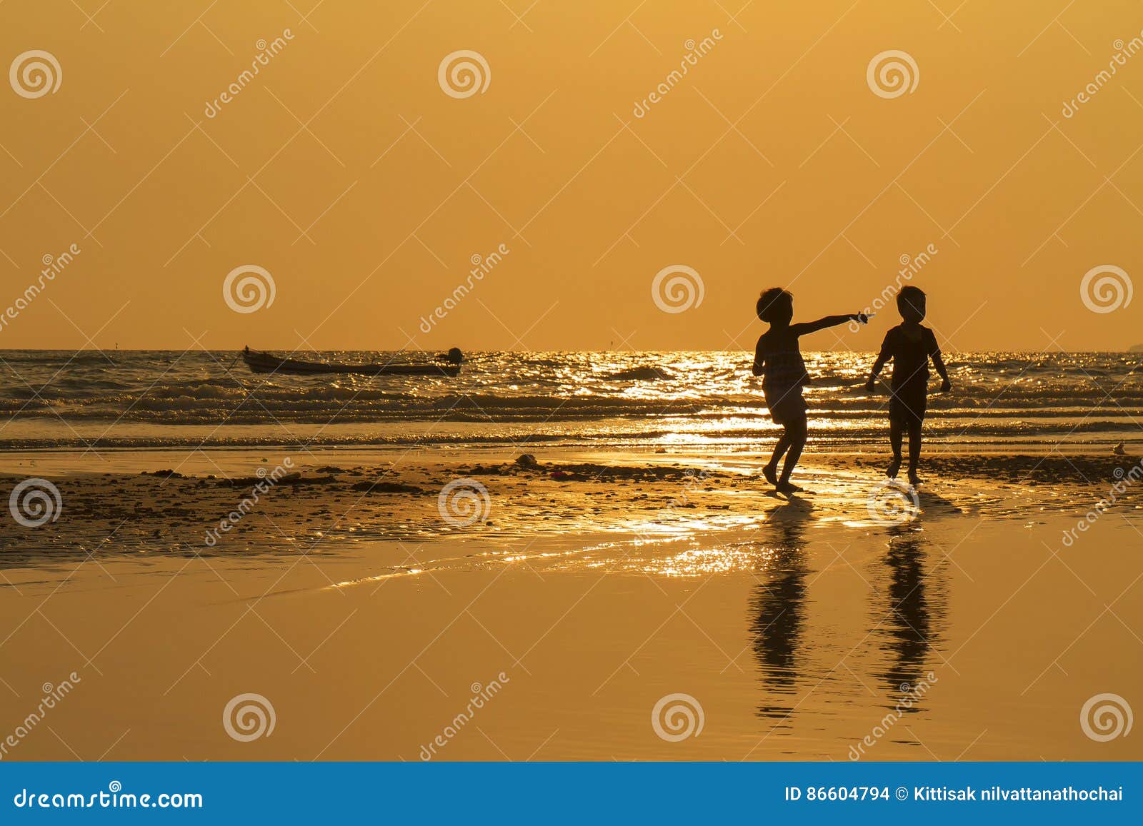 Two Child Shadows on the Beach with Gold Light Sunset Stock Photo ...