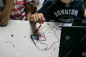 Two Children Build a Prototype Circuit with a Red Laser Controlled by a ...