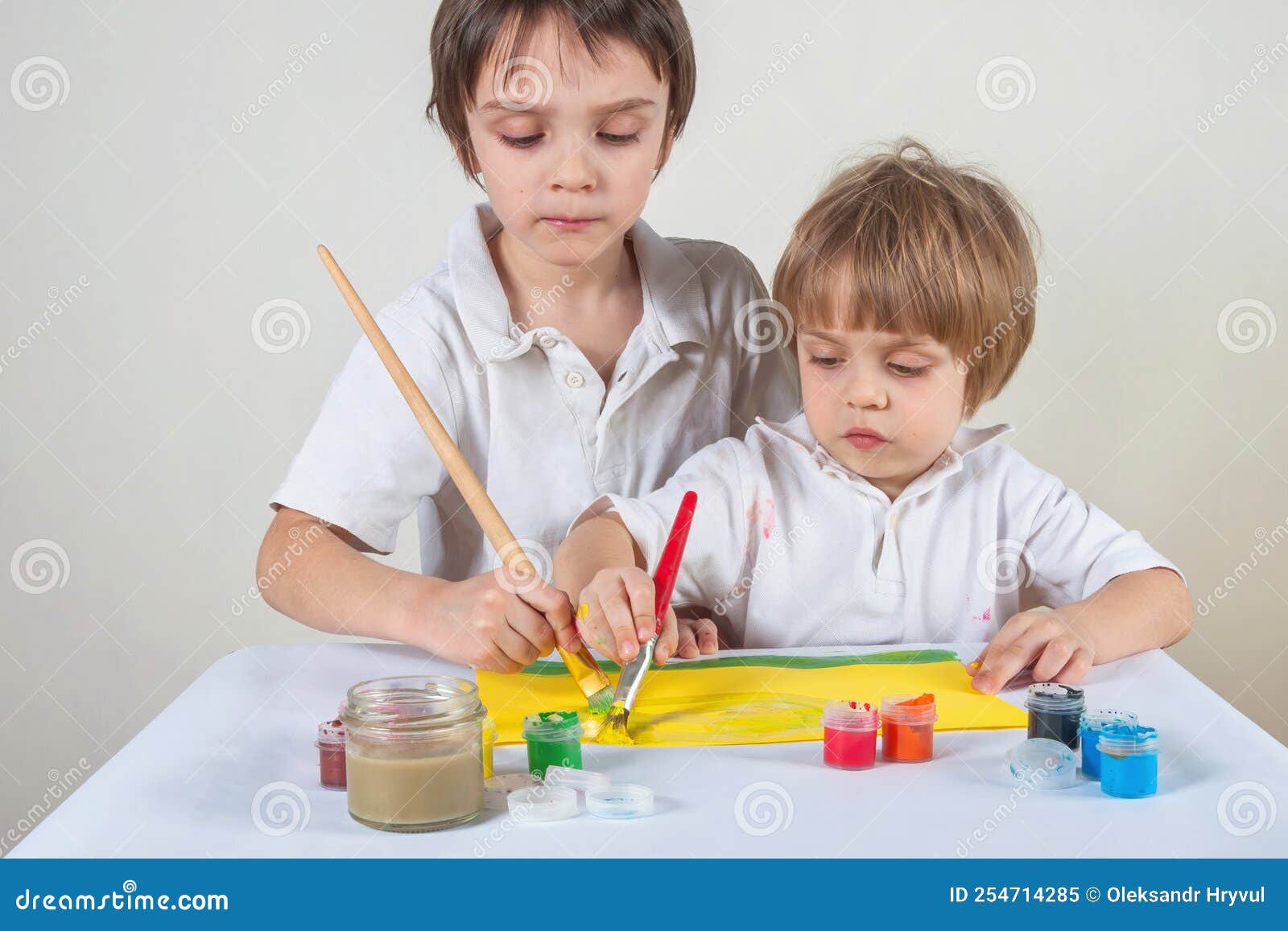 Two Children Draw Together. they Apply Paint To the Paper at the Same ...