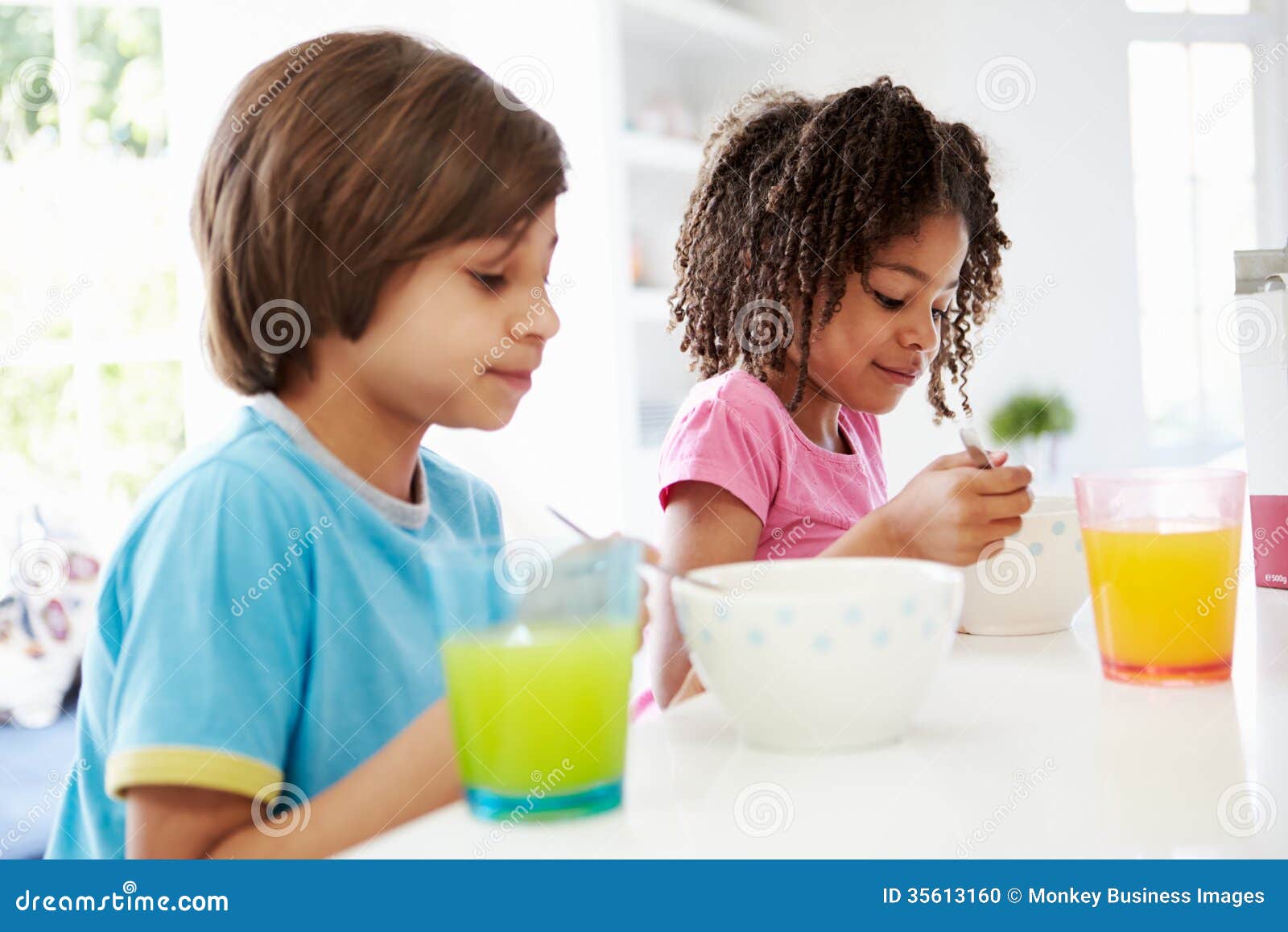 Two Children Having Breakfast in Kitchen Together Stock Photo - Image ...
