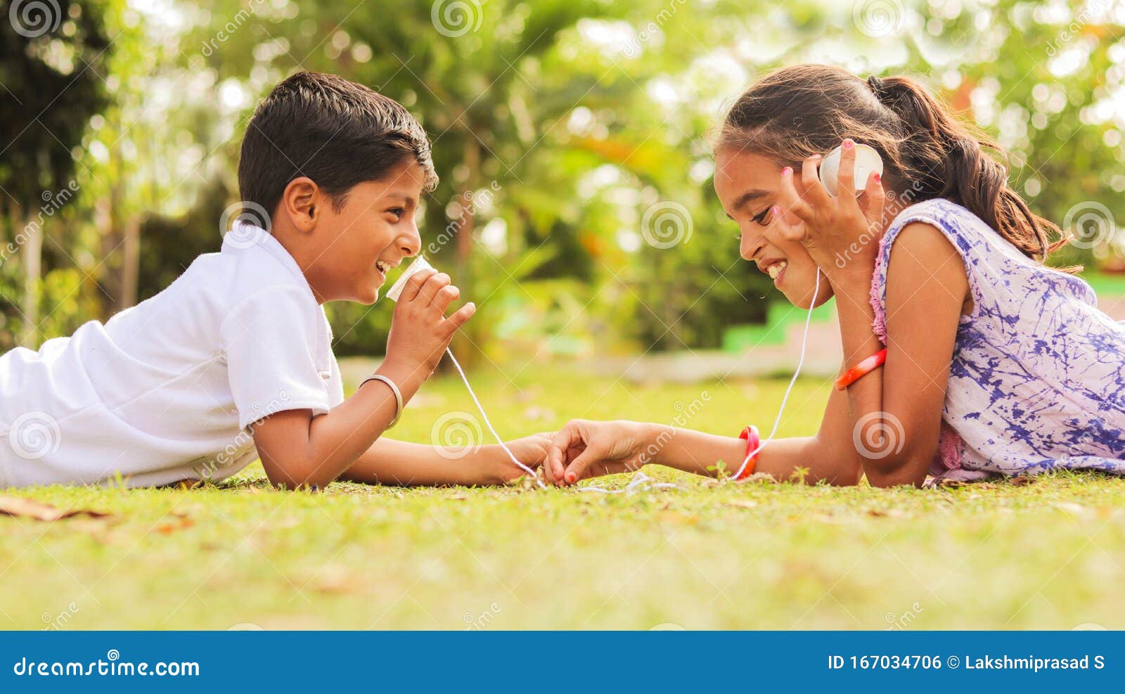 Two Children Having Fun by Playing with String Telephone at Park during ...