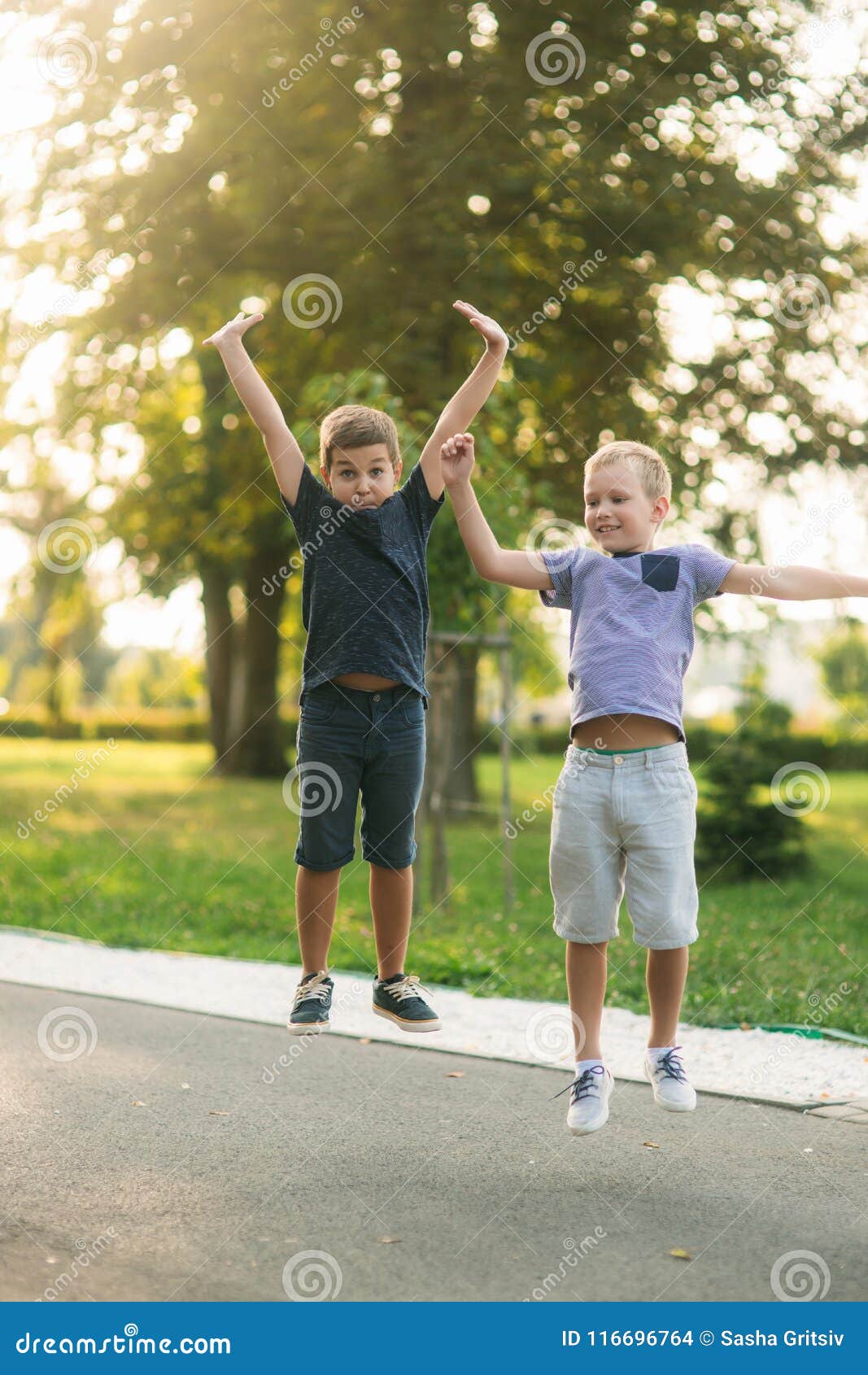 Two Children are Jumping Up in the Air Stock Photo - Image of boys ...