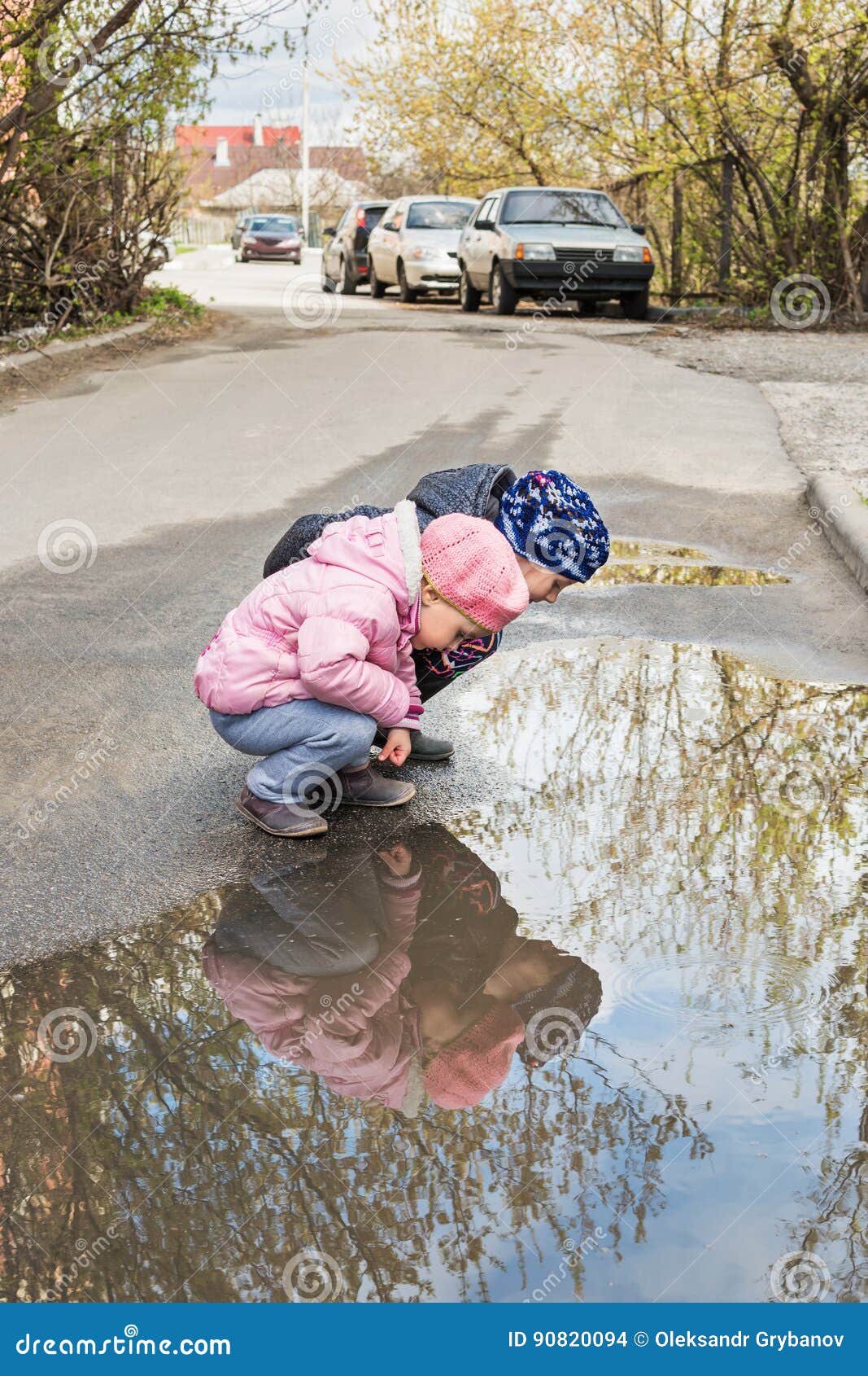 Two Children Look in a Puddle Stock Photo - Image of autumn, people ...