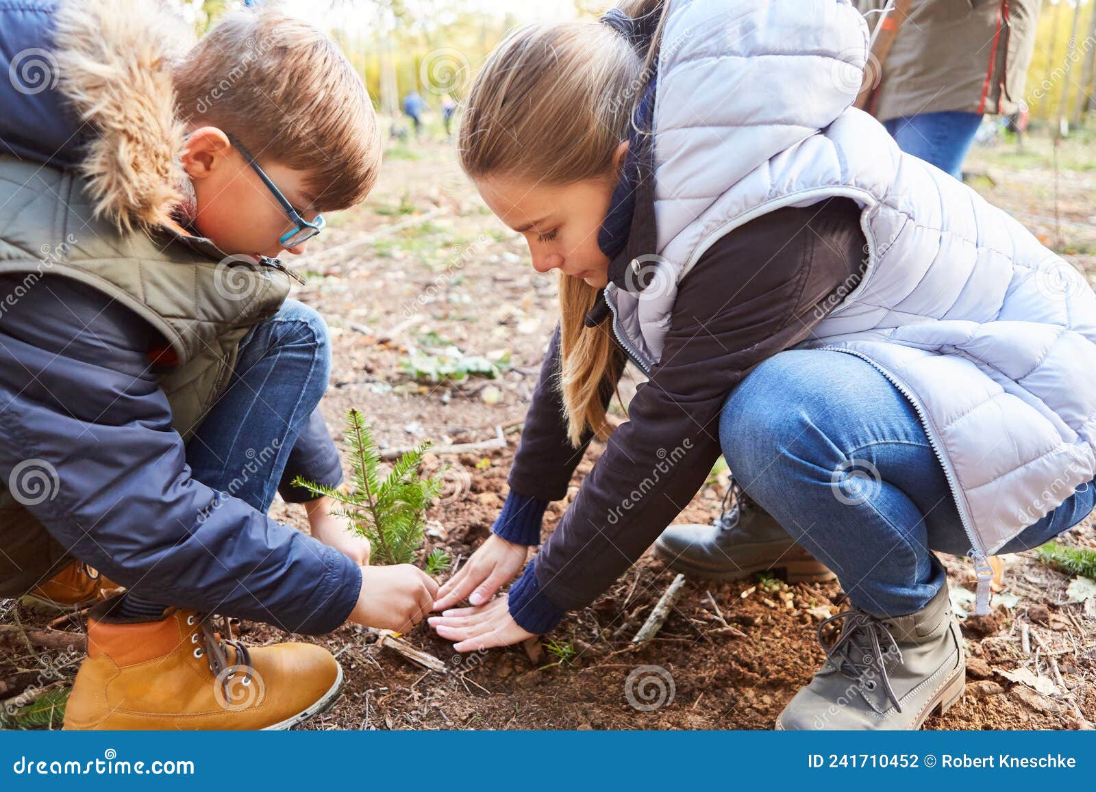 Two Children Planting a Tree in the Forest for Environmental Protection ...