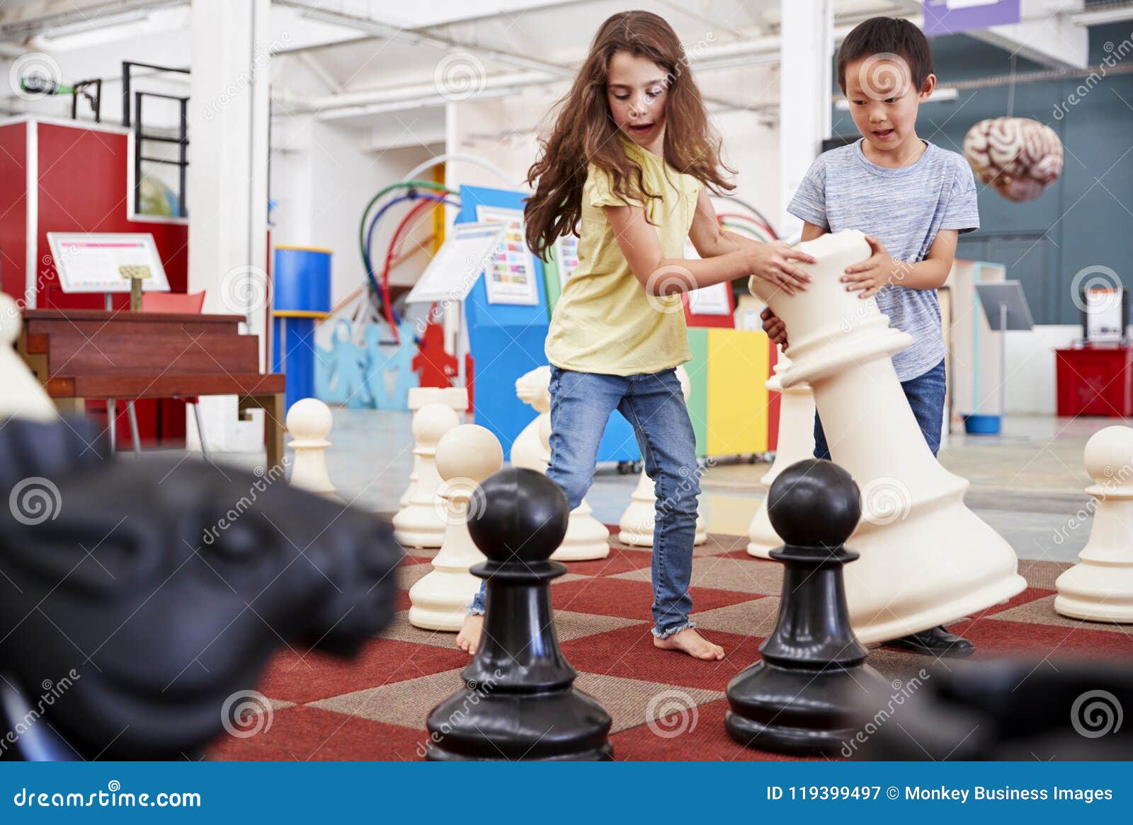 Two Children Playing Giant Chess at a Science Centre Stock Image ...