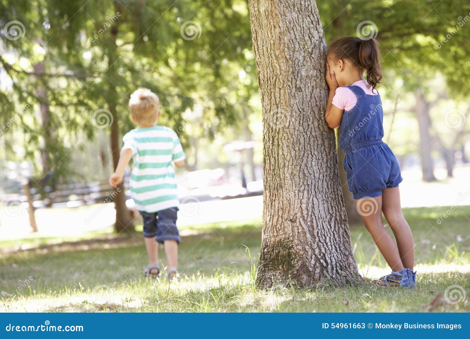 Two Children Playing Hide and Seek in Park Stock Image - Image of year ...