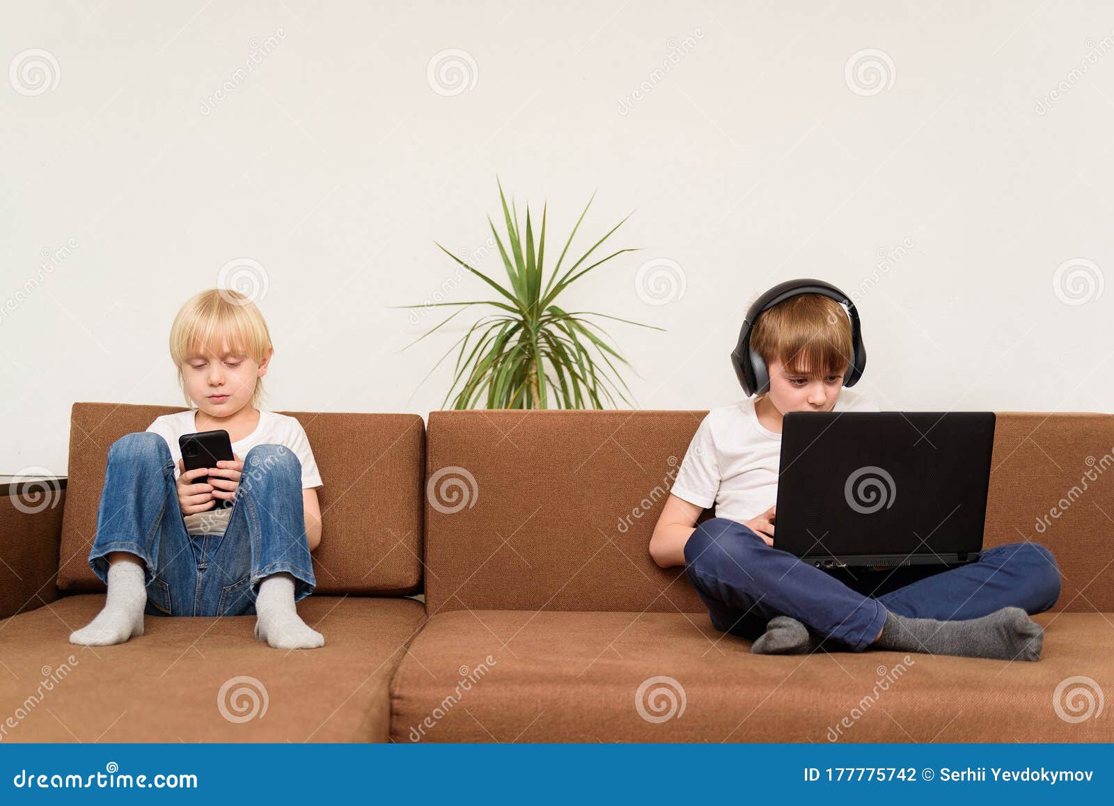 Two Children Sitting on Couch with Gadgets Smartphone and Laptop ...