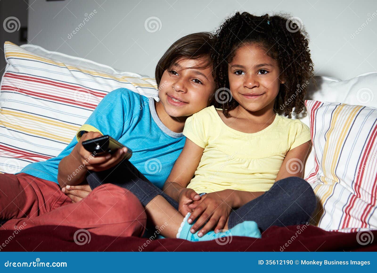 Two Children Sitting on Sofa Watching TV Together Stock Photo - Image ...