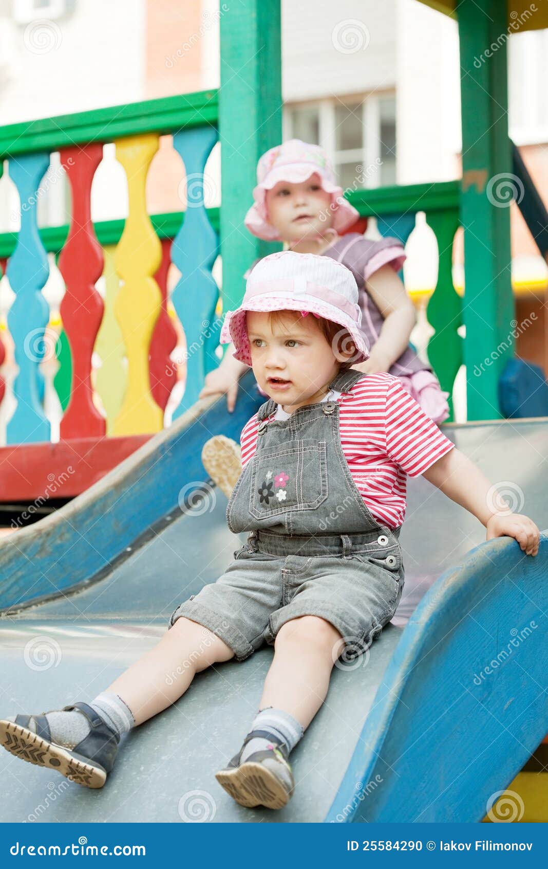 Two children on slide stock photo. Image of playful, playground - 25584290