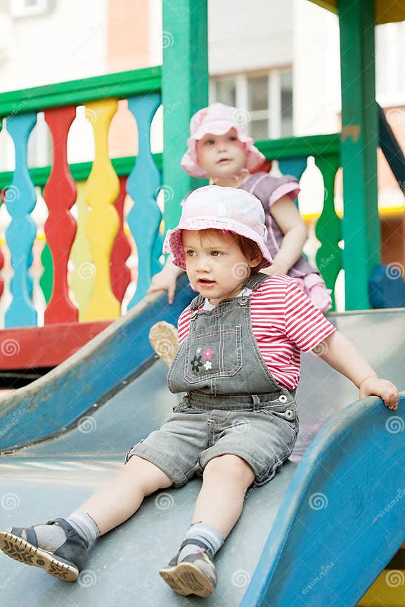 Two children on slide stock photo. Image of playful, playground - 25584290