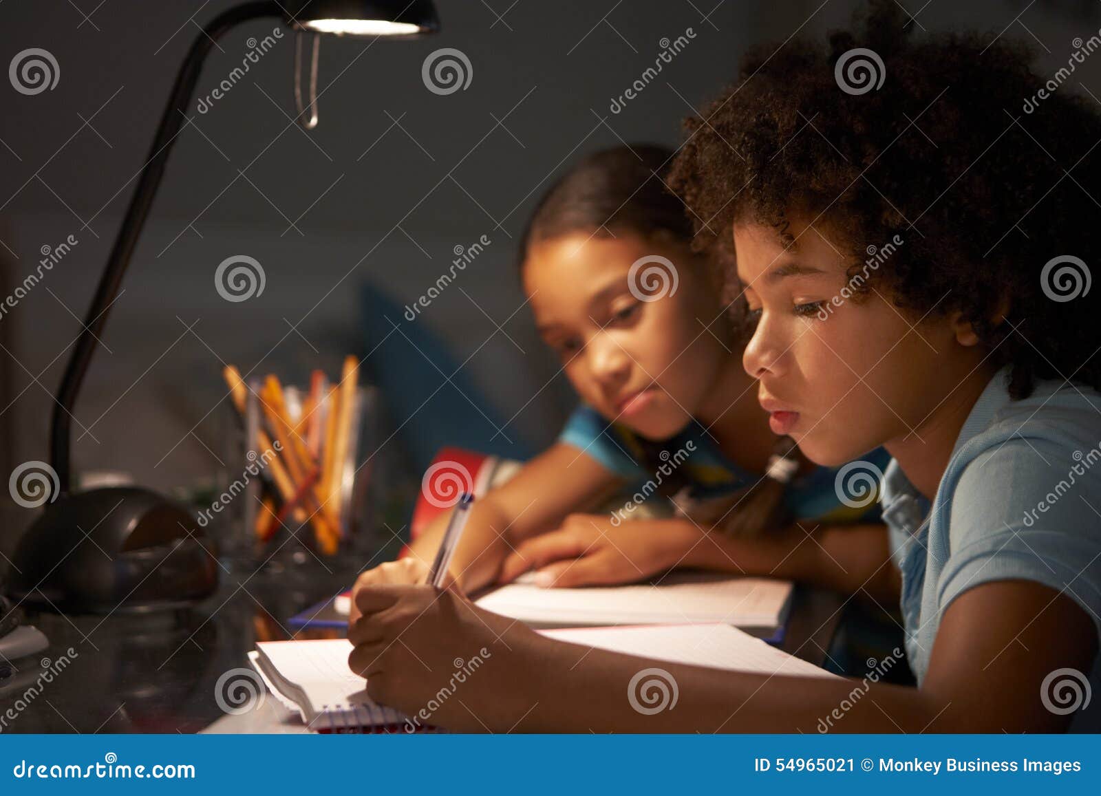 Two Children Studying at Desk in Bedroom in Evening Stock Image - Image ...
