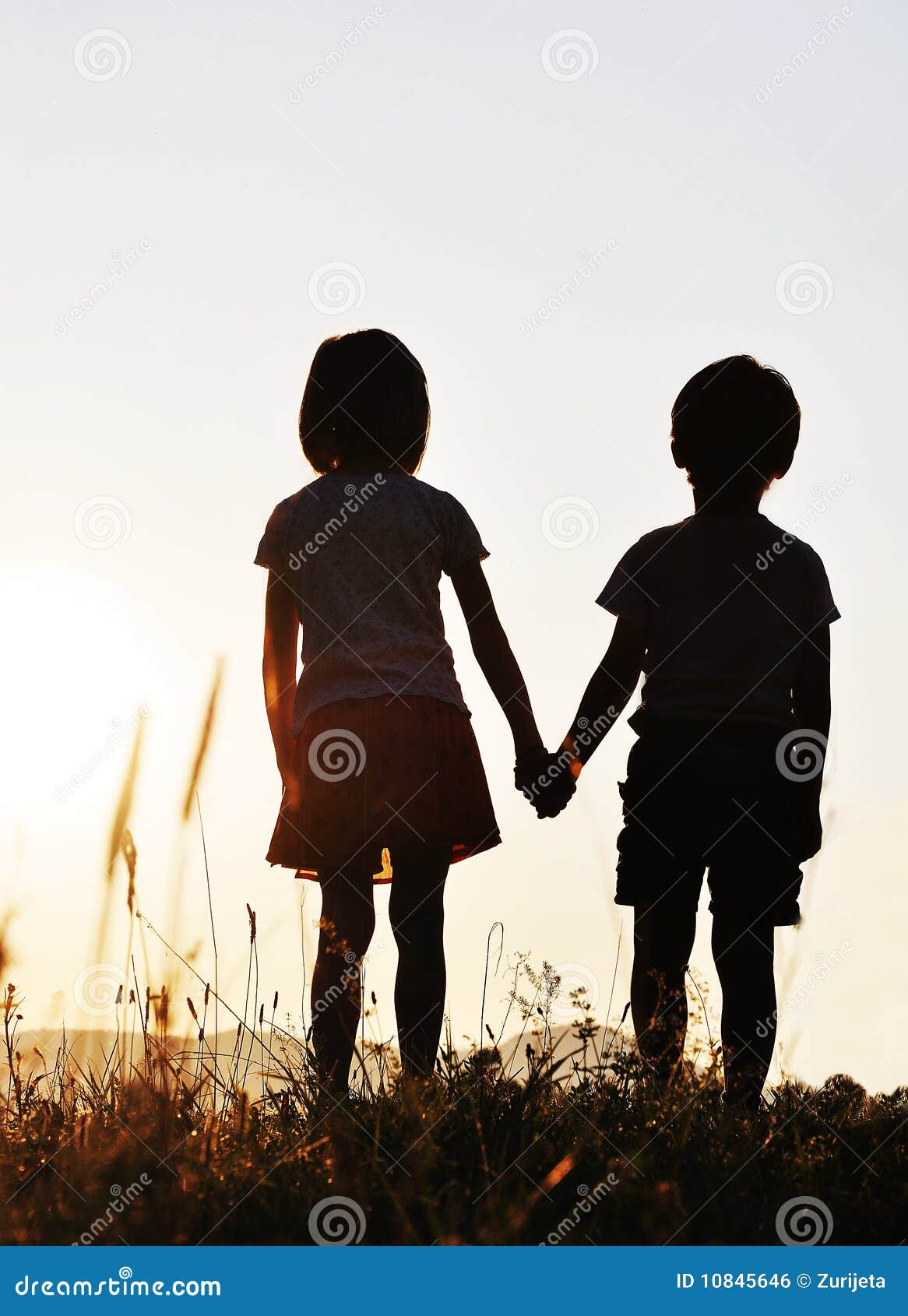 Children At Sunset In The Field Show A Heart From Their Fingers. Walk ...