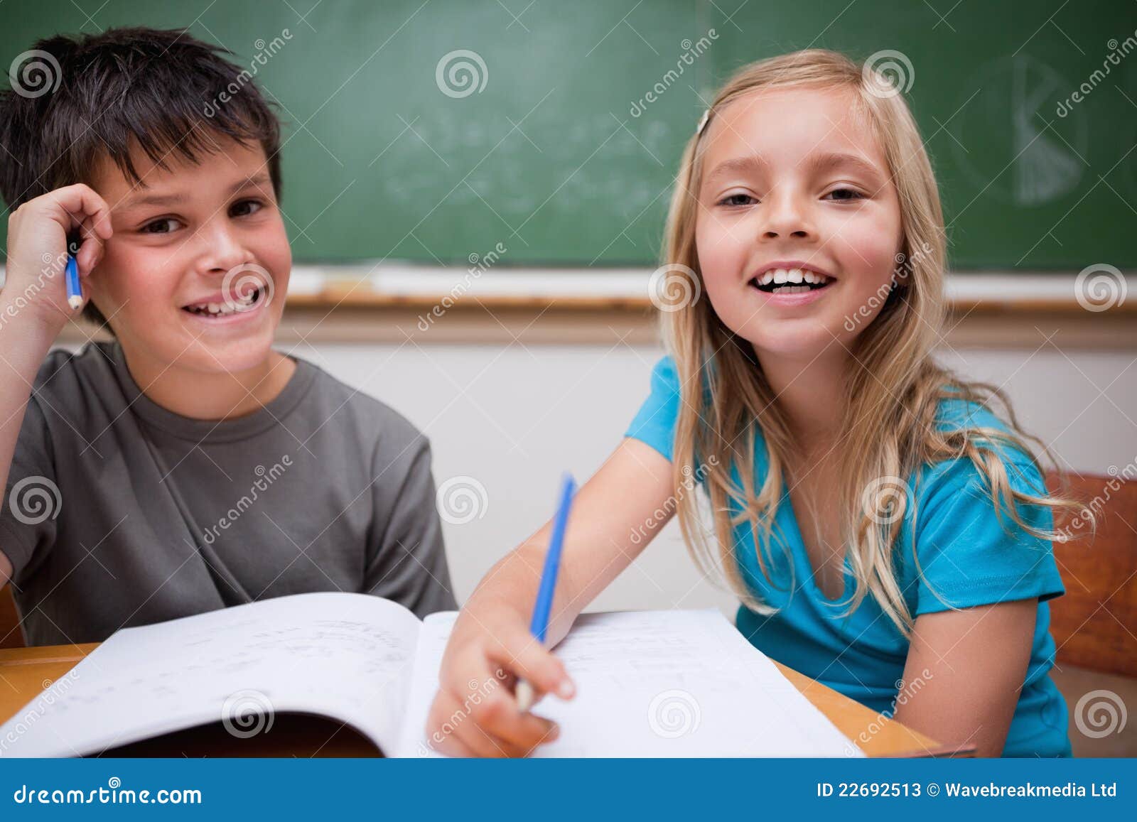 Two children writing stock image. Image of girl, clever - 22692513