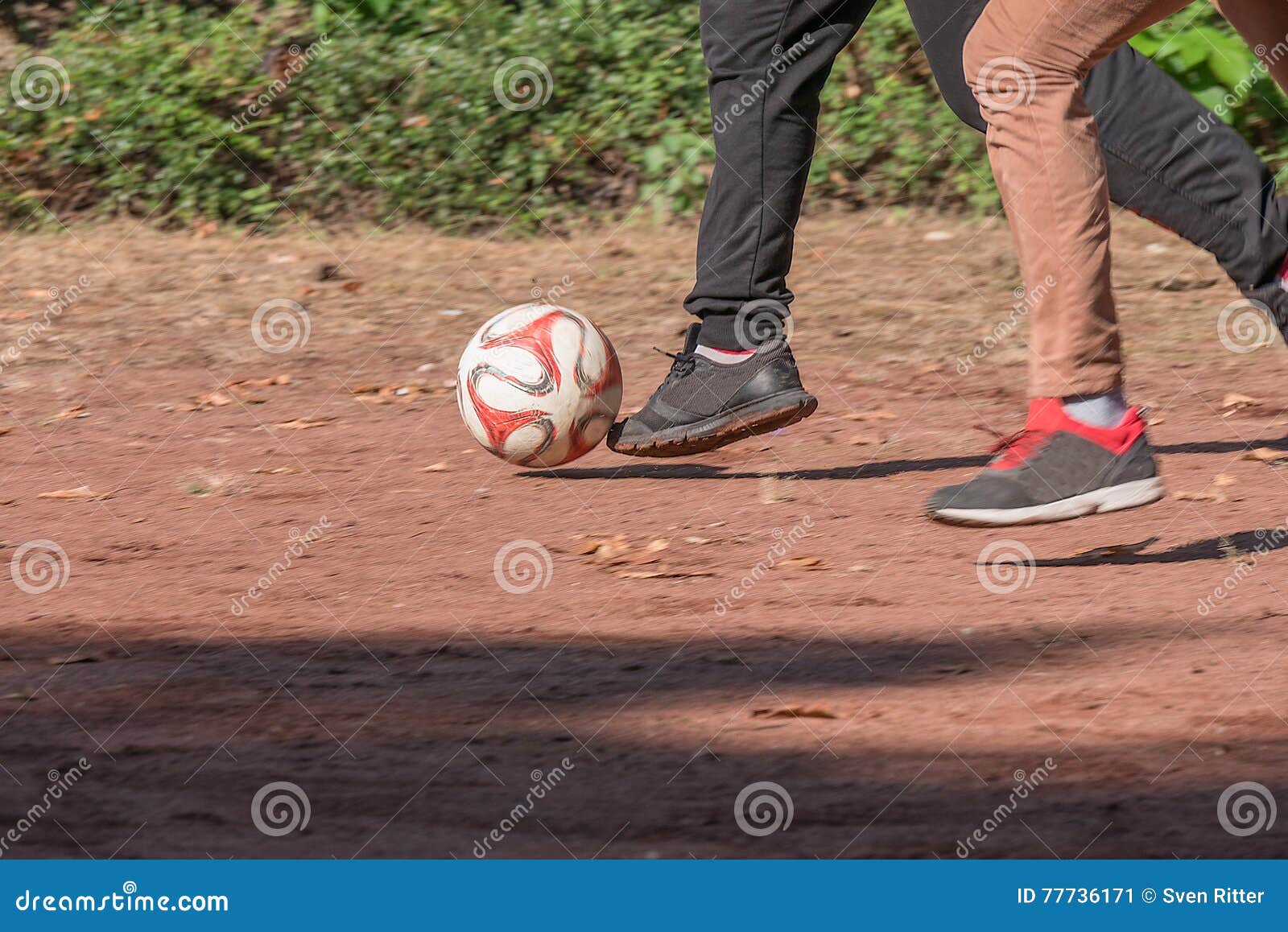Two childs chasing a ball stock image. Image of green - 77736171