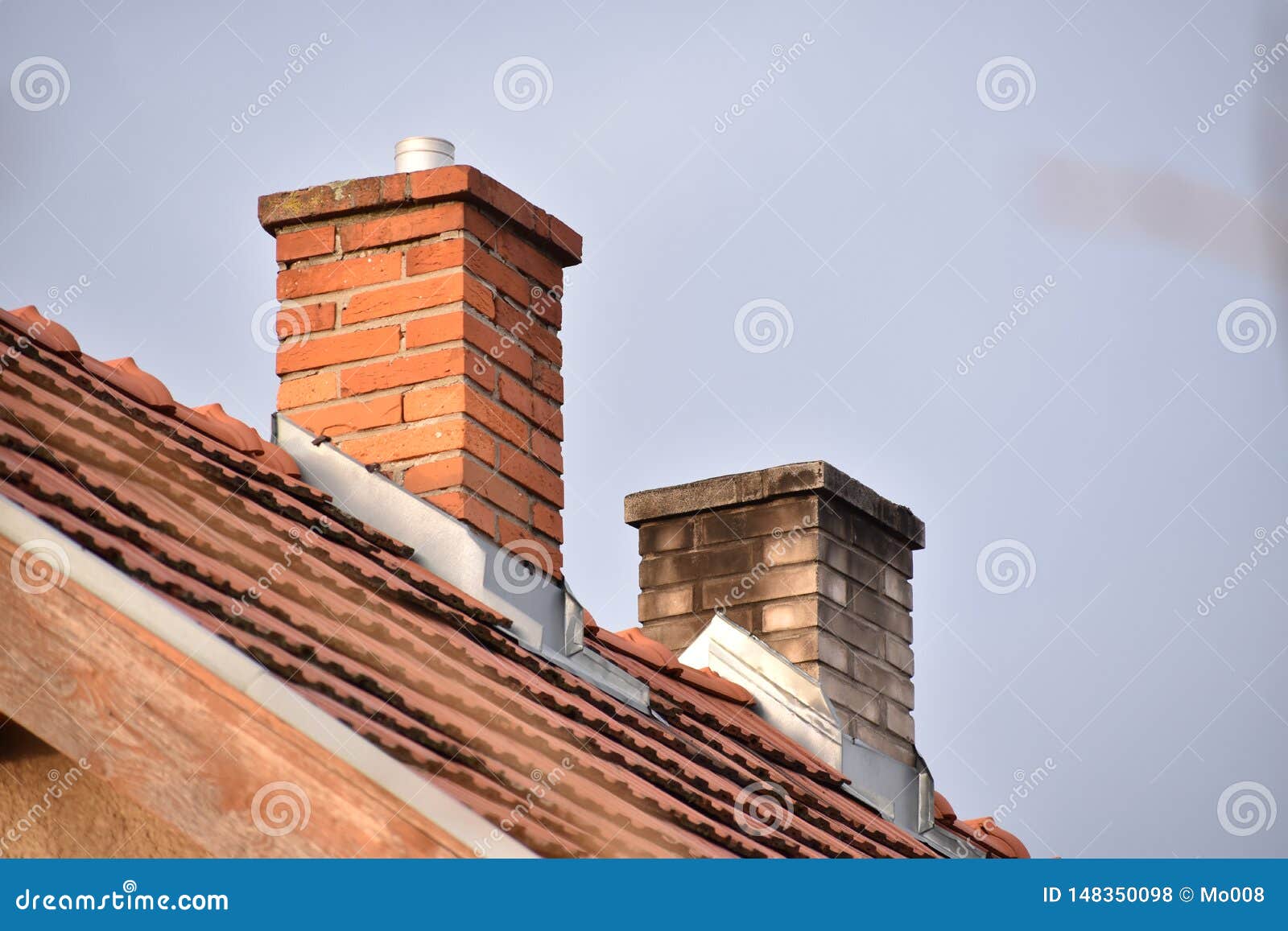 Two chimneys on the house stock photo. Image of orange - 148350098