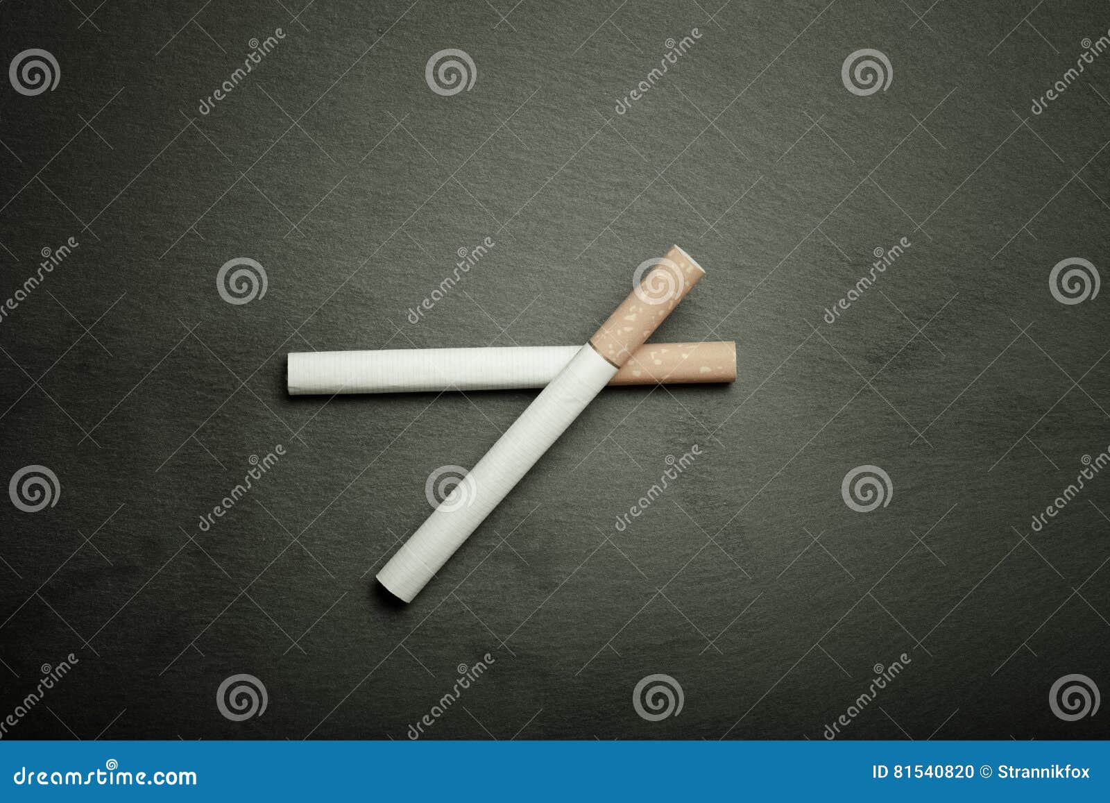 Two Cigarettes on a Black Slate Cutting Board. Toned Stock Photo ...