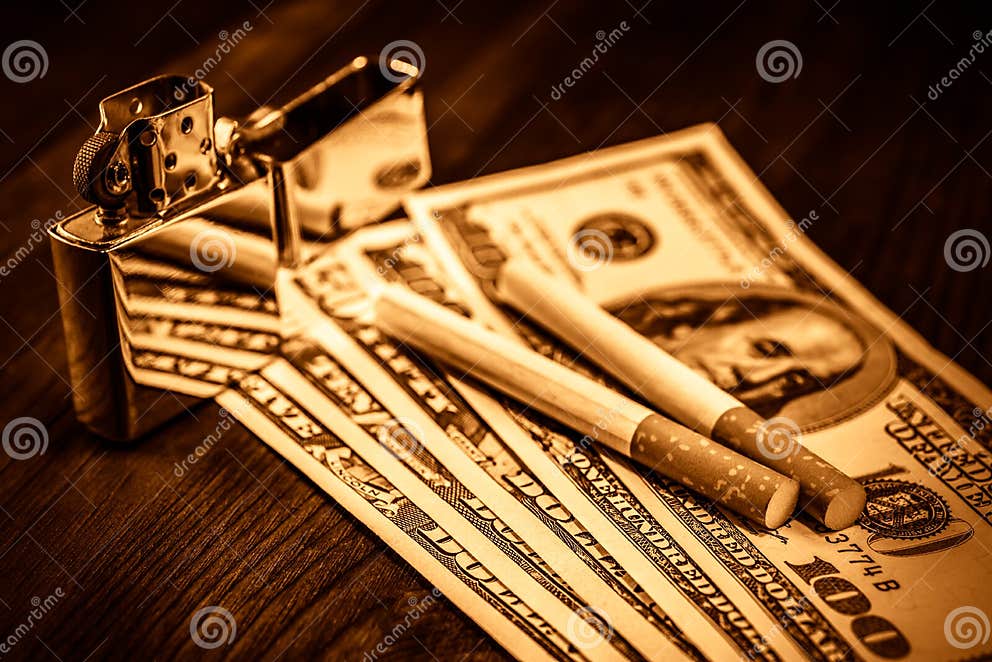 Two Cigarettes and Open Lighter are on the Dollars. Stock Photo - Image ...