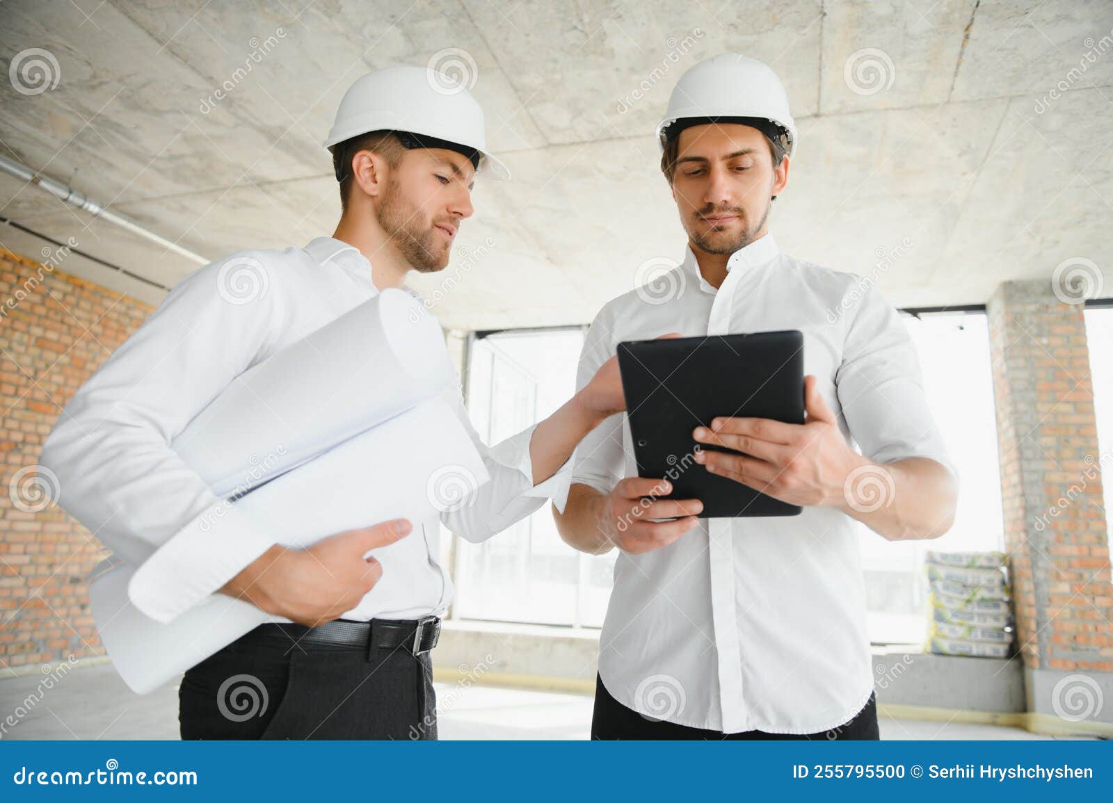 Two Civil Engineers or Architects Man Inspecting Construction of House ...