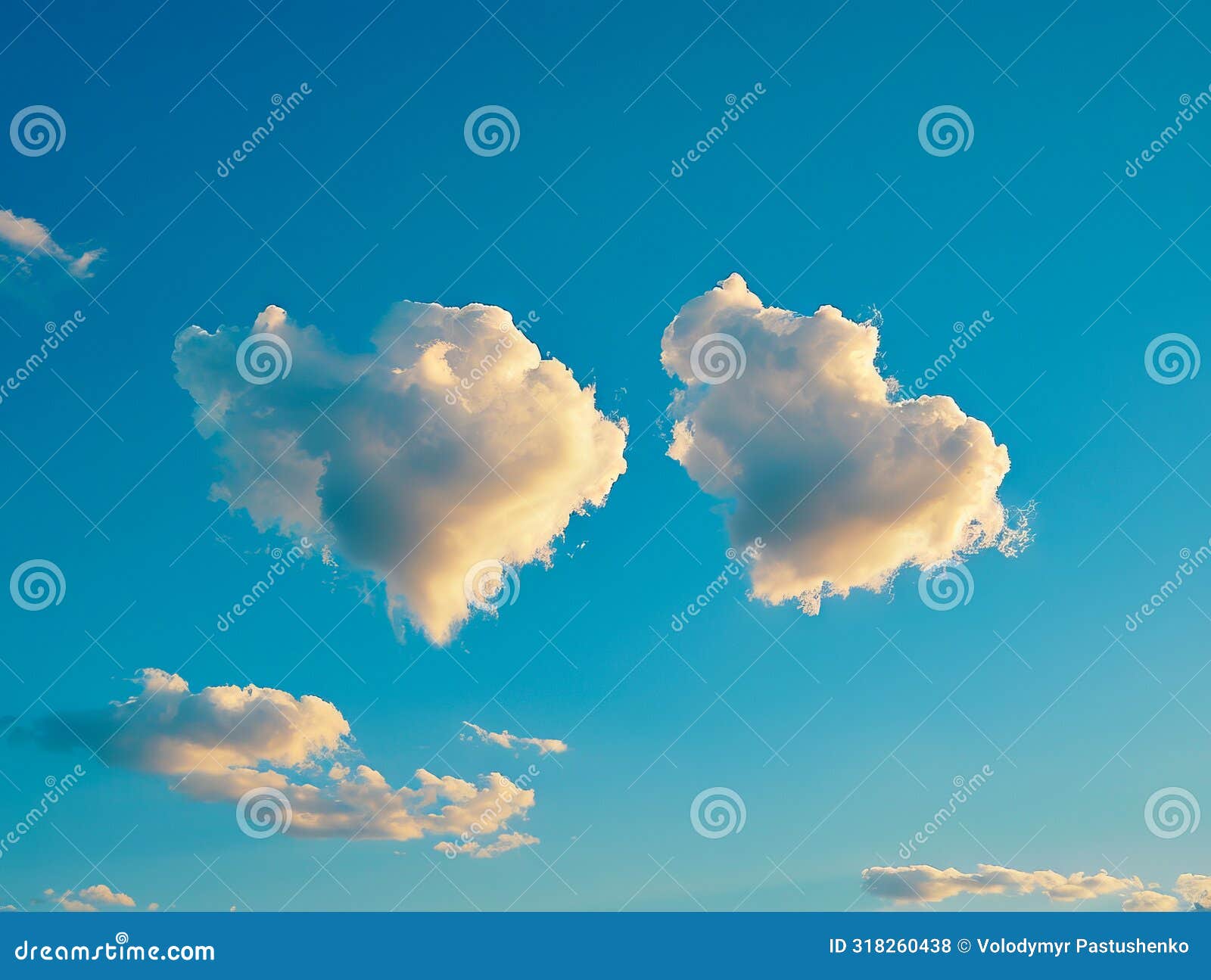 Two Clouds in the Sky with a Blue Background Stock Photo - Image of ...