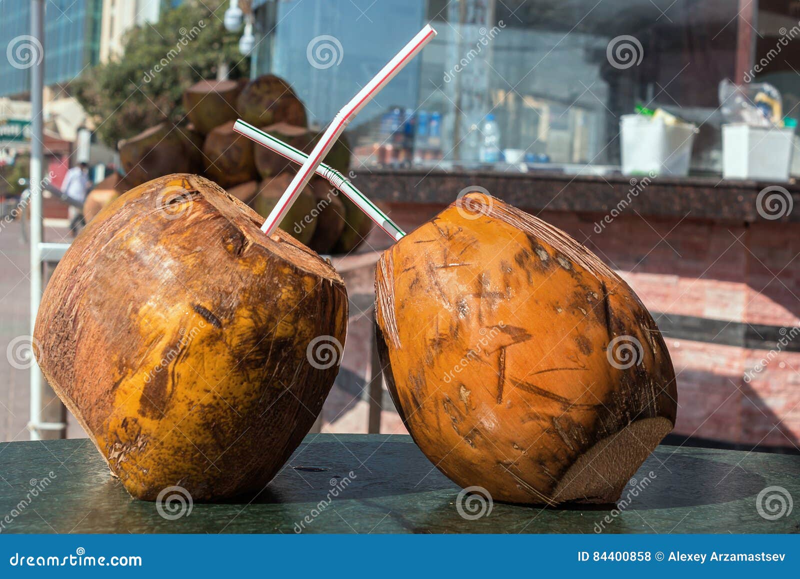 Two Coconuts with Straws To Drink on the Table. Refreshment Stock Photo ...