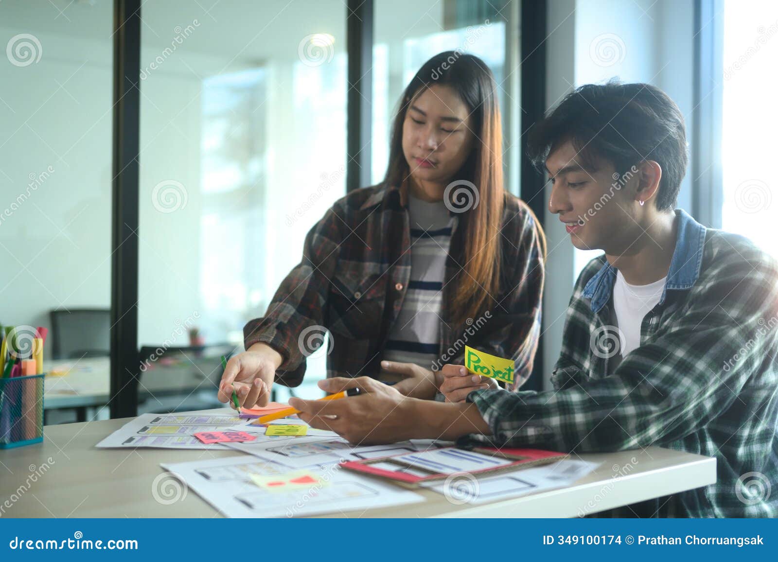 Two Colleagues Collaborating on App Design Wireframes and Using ...