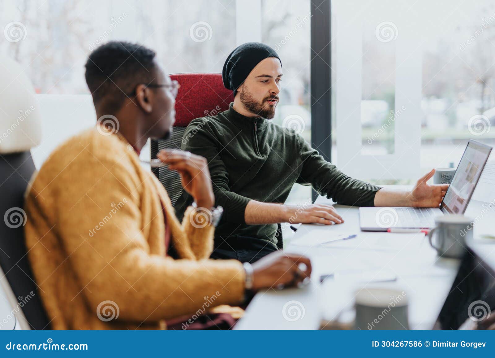 Two Colleagues Collaborating in a Startup Office, Discussing Tasks ...