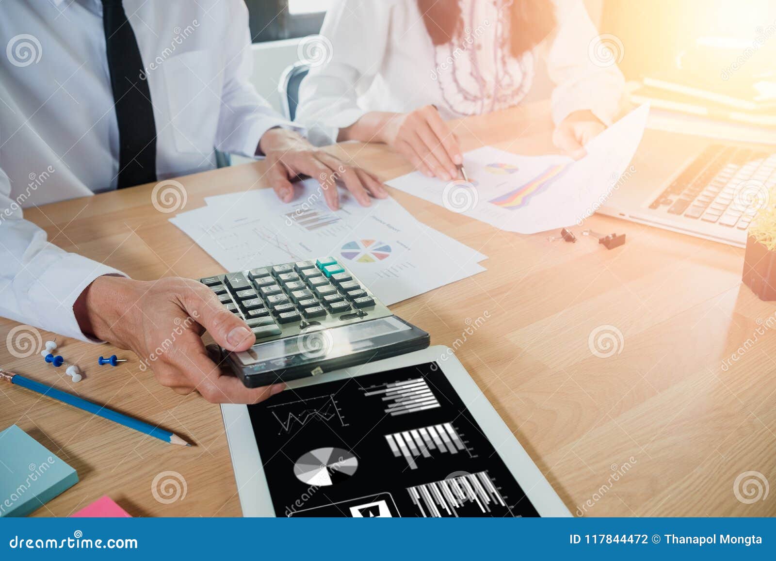 Two Colleagues Discussing Data with Calculator Stock Photo - Image of ...