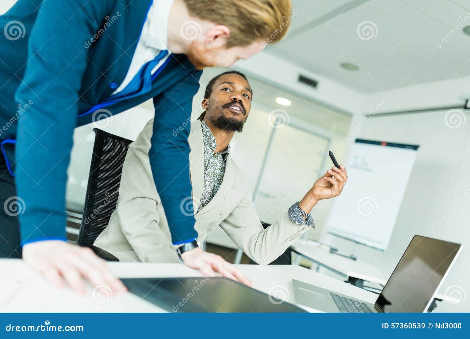 Two Colleagues Discussing Graphics Design Flaws in a Nice White Stock ...