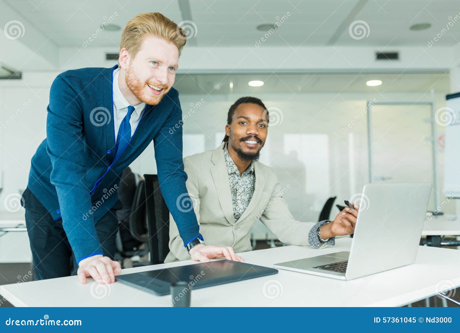 Two Colleagues Discussing Graphics Design Flaws in a Nice White Stock ...