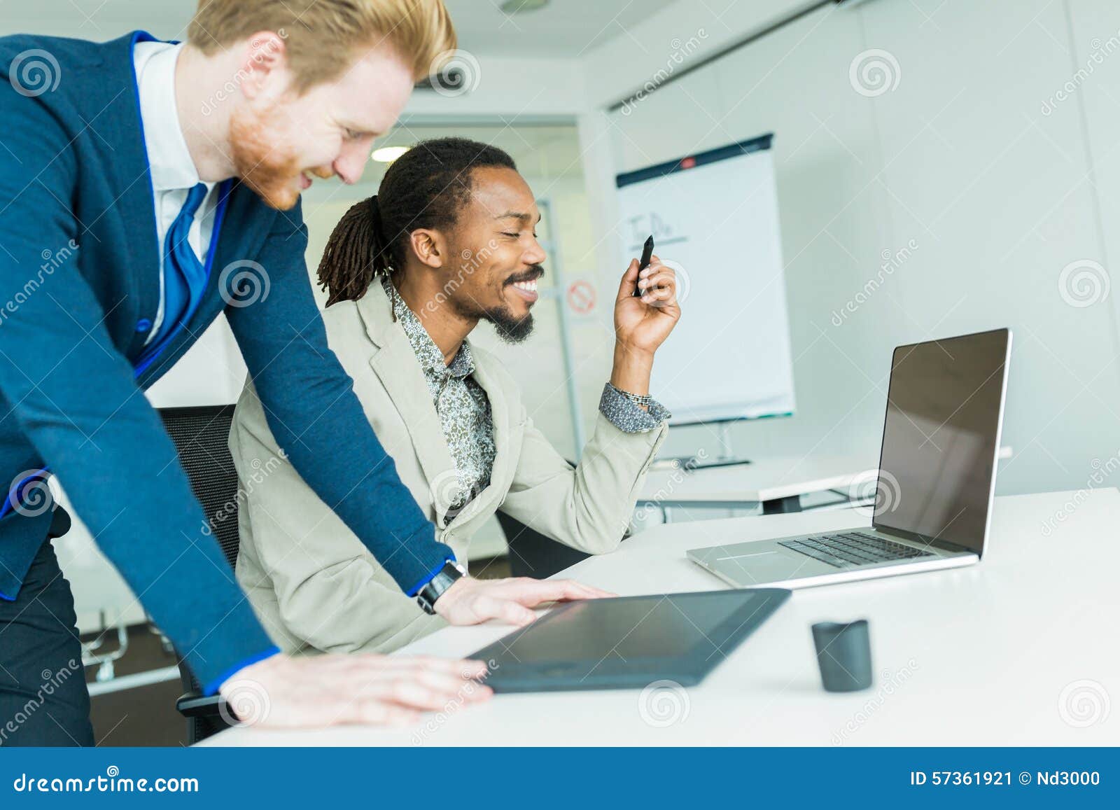 Two Colleagues Discussing Graphics Design Flaws in a Nice White Stock ...