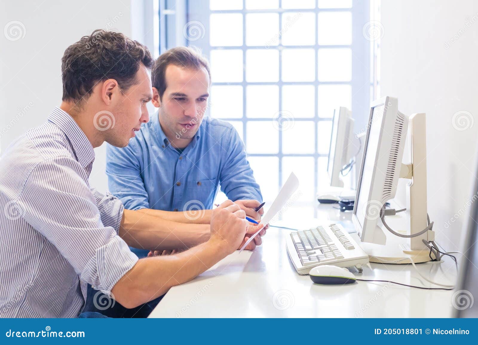 Two Colleagues Discussing Together about a Project in Modern Office ...