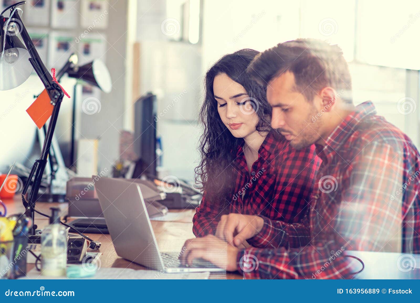 Two Colleagues Discussing Work on a Laptop. Stock Image - Image of ...
