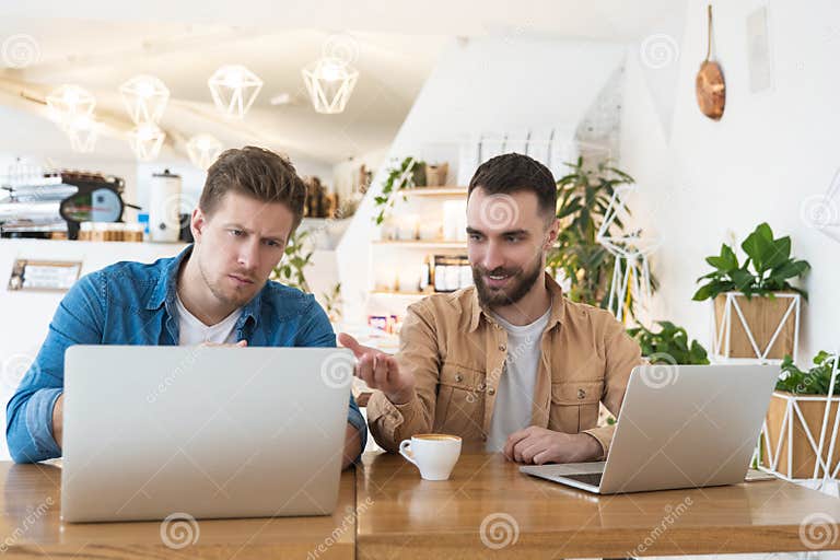 Two Colleagues Men Discussing Work Issues during Lunch Break at Cafe ...