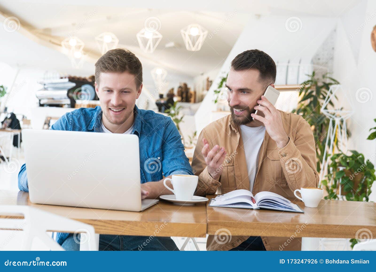 Two Colleagues Men Discussing Work Issues during Lunch Break at Cafe ...