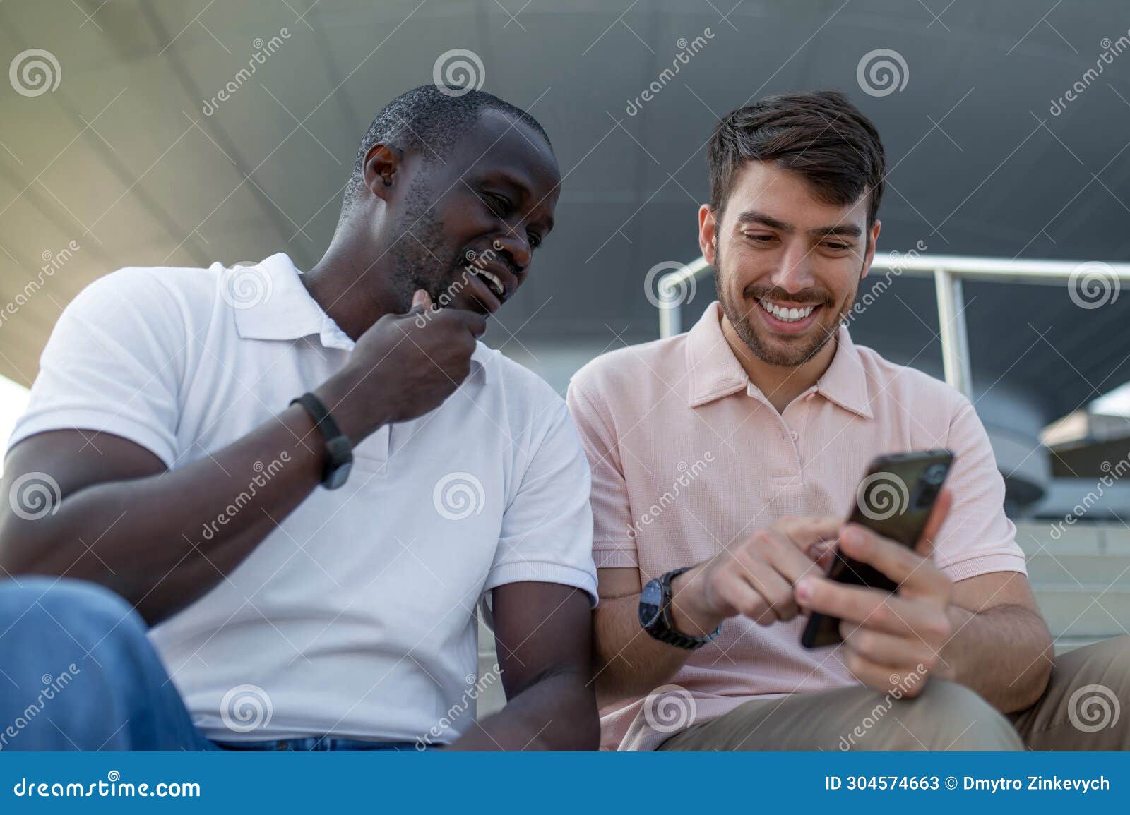 Two Colleagues Sitting Together on Steps and Talking Stock Image ...