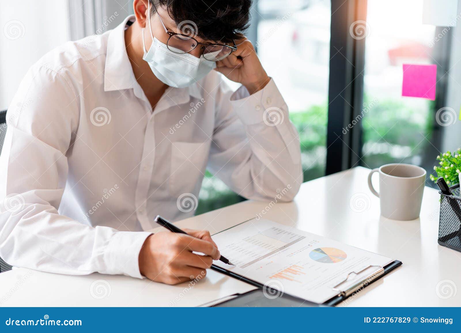 Two Colleagues Wearing Surgical Masks Analyzing the Data in Chart for ...